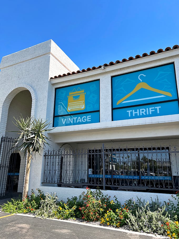 Spanish-style architecture meets thrift store magic. Those blue window displays aren't just pretty&mdash;they're promises of treasures inside.