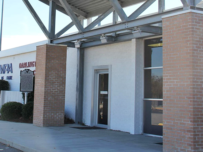 First impressions matter. The unassuming brick entrance belies the treasure trove of racing legends waiting just beyond those doors.