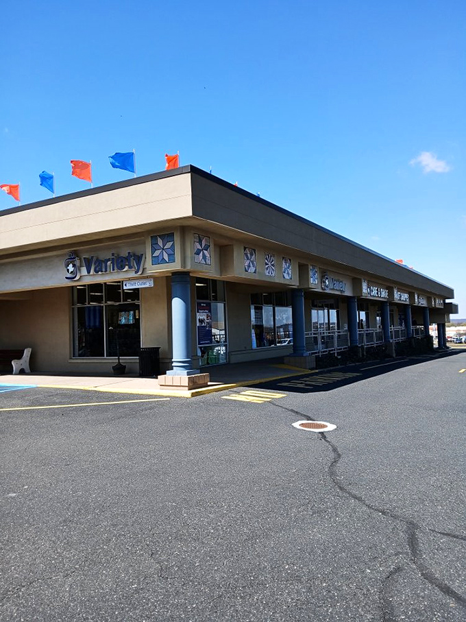 The unassuming exterior belies the treasure trove within. Those colorful flags aren't just decoration&mdash;they're waving you in for an adventure in secondhand paradise. 