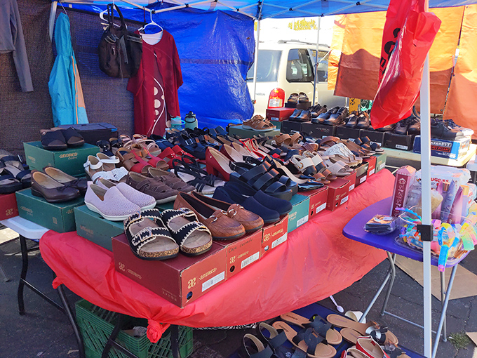 A footwear fantasia awaits! From practical flats to statement sandals, this vendor's display proves that Cinderella would never have needed a fairy godmother at the Laney College Flea Market.