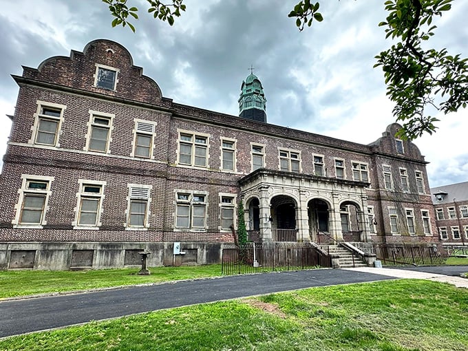 The imposing administration building with its distinctive cupola stands as a silent sentinel to history, brooding under Pennsylvania's moody skies.