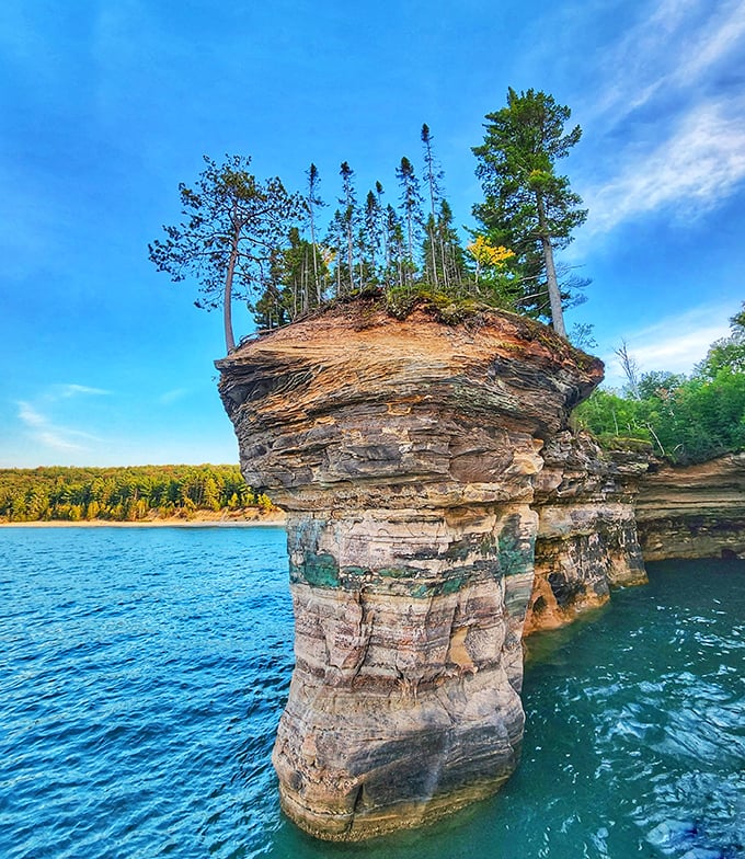 This rock formation looks like nature's attempt at a wedding cake, complete with colorful mineral "frosting" and trees for candles.