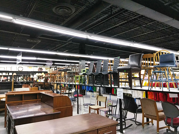 Chairs hanging from the ceiling like some domestic chandelier. Mid-century pieces mingle with country tables in this furniture forest of possibilities.