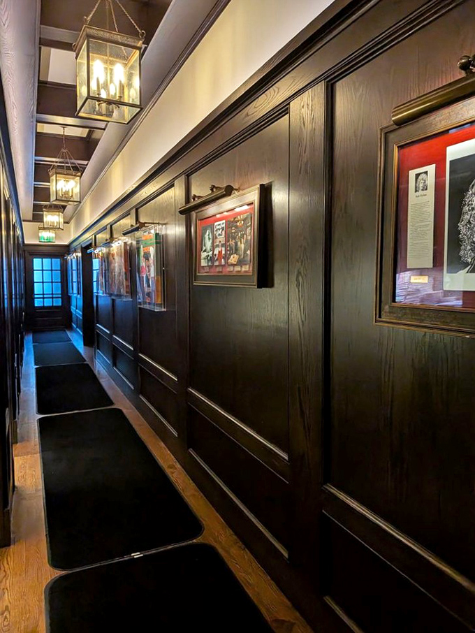 Dark wood paneling and vintage lighting create a corridor through time. This hallway has witnessed a century of Hollywood's most fascinating conversations.