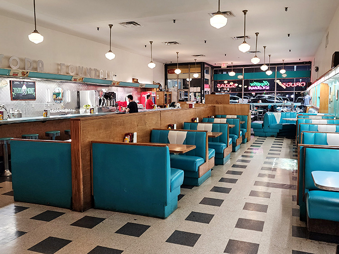 Turquoise booths line up like faithful soldiers guarding a temple of comfort food, their vinyl seats holding decades of Jackson stories.