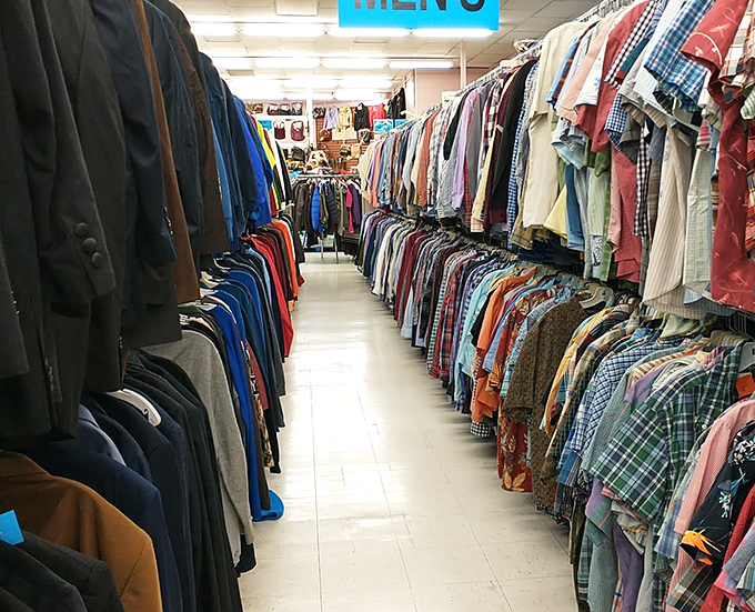 Endless racks of possibility stretch before you—each aisle a time machine through decades of fashion history and personal stories.