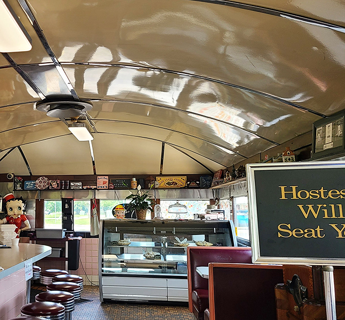Step inside and time travel begins. The curved ceiling, counter seating with those classic swivel stools, and Betty Boop figure create the perfect nostalgic atmosphere.