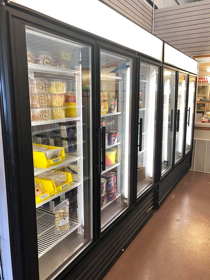 A treasure trove of dairy delights awaits behind these refrigerated doors, where cheese varieties line up like contestants in a delicious pageant.