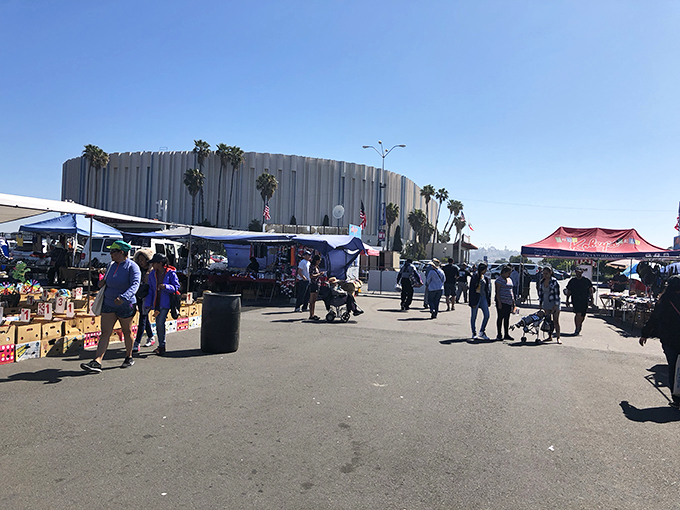 The Sports Arena looms in the background like a coliseum of commerce, while shoppers hunt for deals under the California sun.