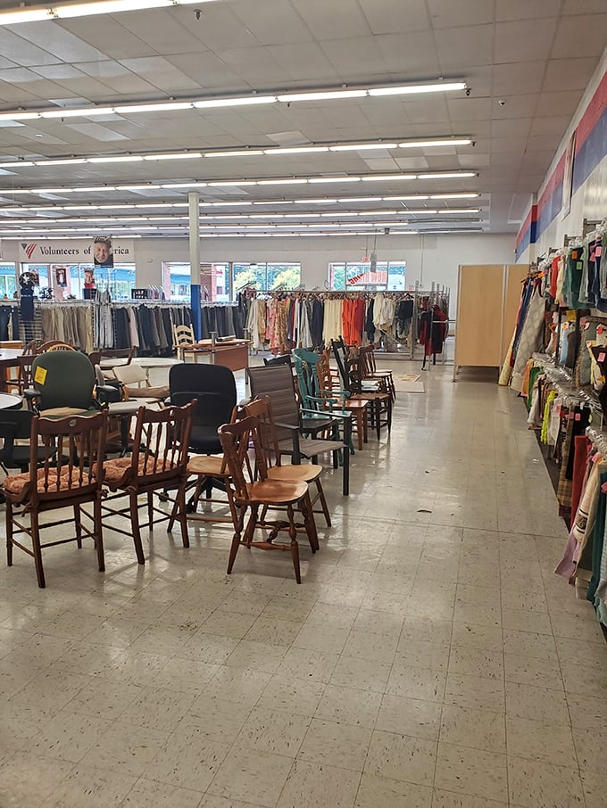 Wooden chairs waiting for their next story to begin, while racks of potential wardrobe transformations line the horizon of possibility.
