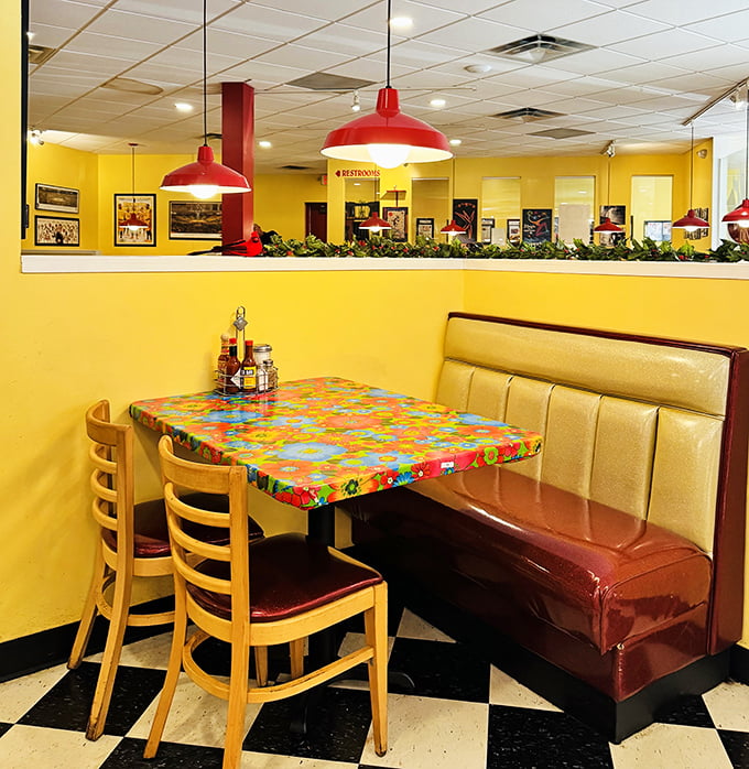 Sunshine-yellow walls and cherry-red booths create the perfect backdrop for life-changing breakfast decisions. The colorful tables are just a preview of what's to come.