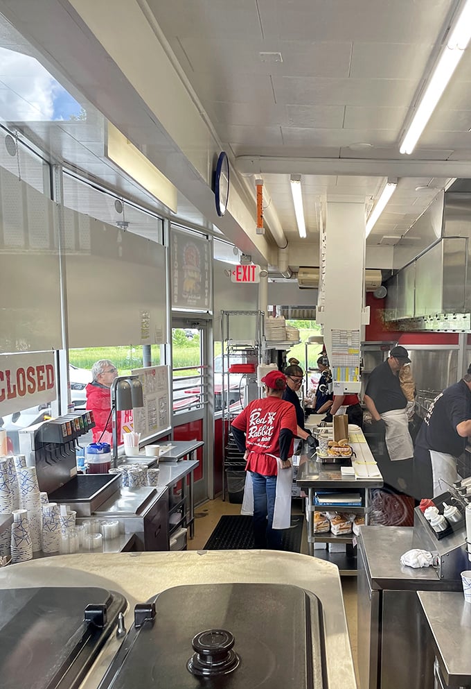 Behind the counter, a well-choreographed culinary ballet unfolds. Red-shirted staff work with the precision of a NASCAR pit crew during lunch rush.