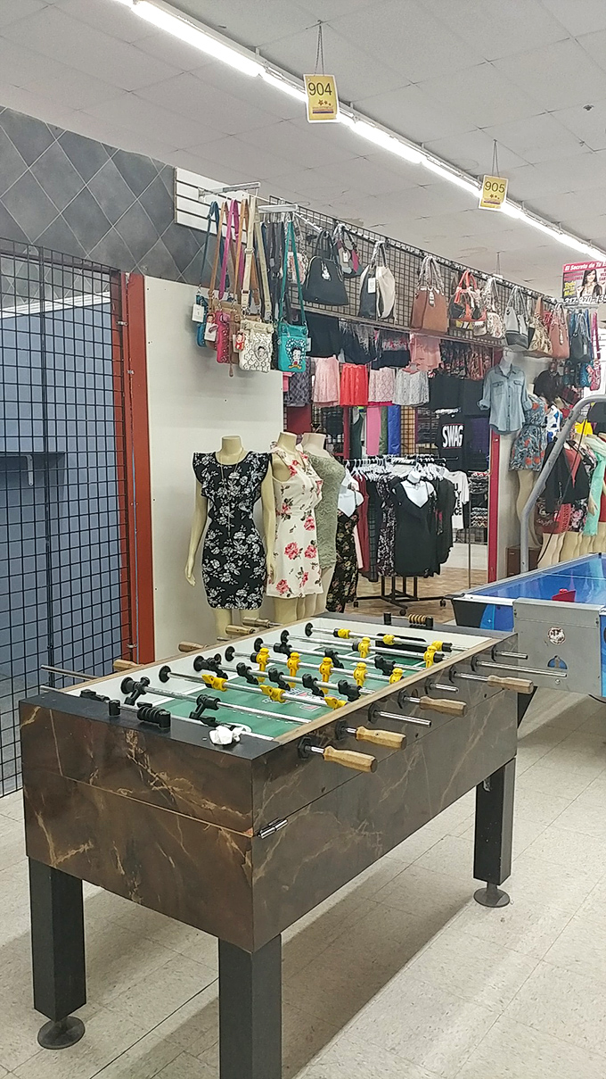 Where fashion meets foosball! This vendor's creative display showcases both stylish dresses and entertainment options&mdash;proof that shopping here is never just shopping.