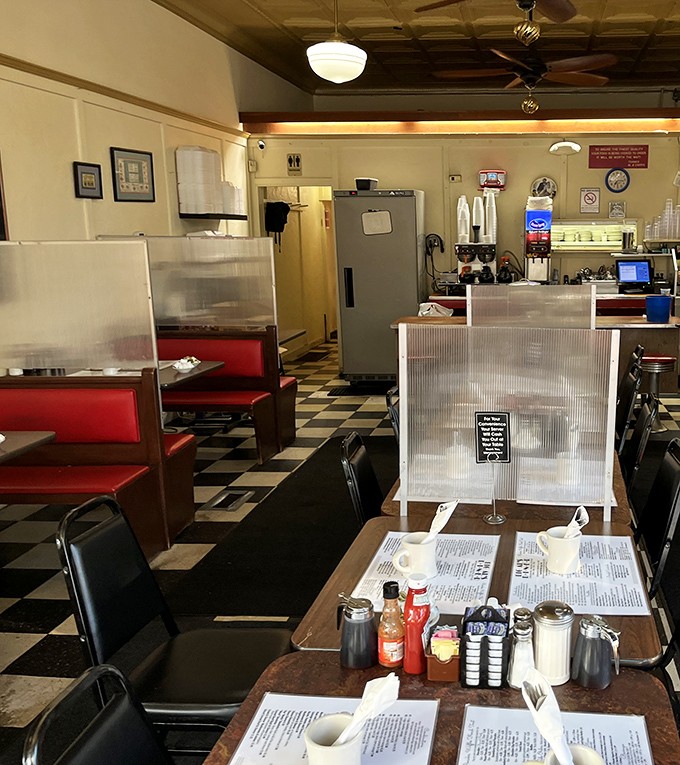 Classic diner perfection with checkerboard floors and red vinyl booths. This isn't retro by design&mdash;it's authentic by survival.