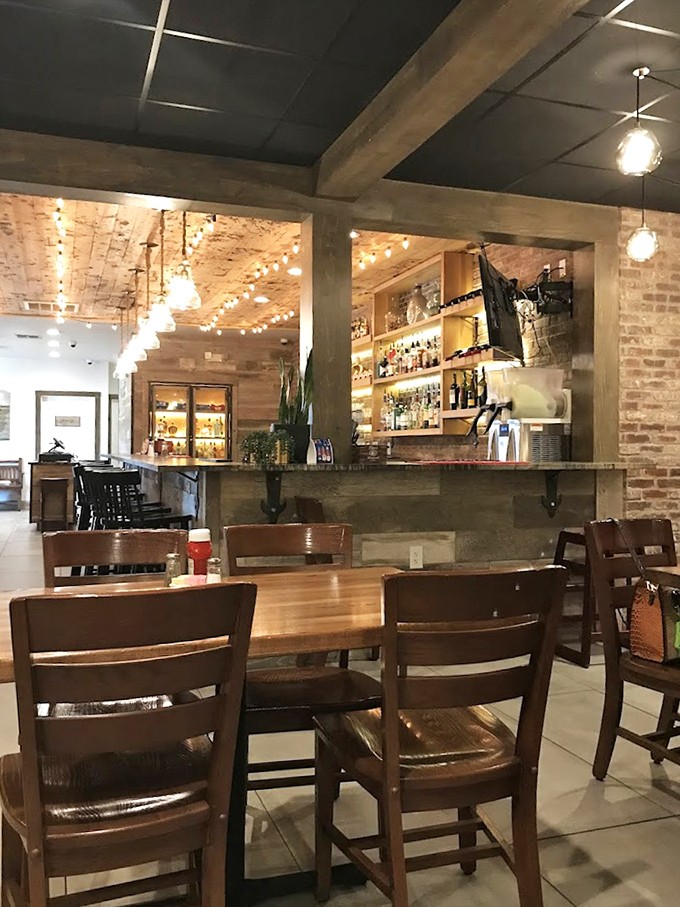 Exposed brick and string lights create the perfect atmosphere where comfort meets sophistication beautifully.