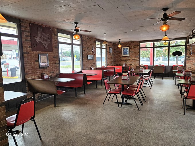 Red vinyl booths, brick walls, and ceiling fans spinning stories of decades past—this isn't retro by design, it's authentic by survival.