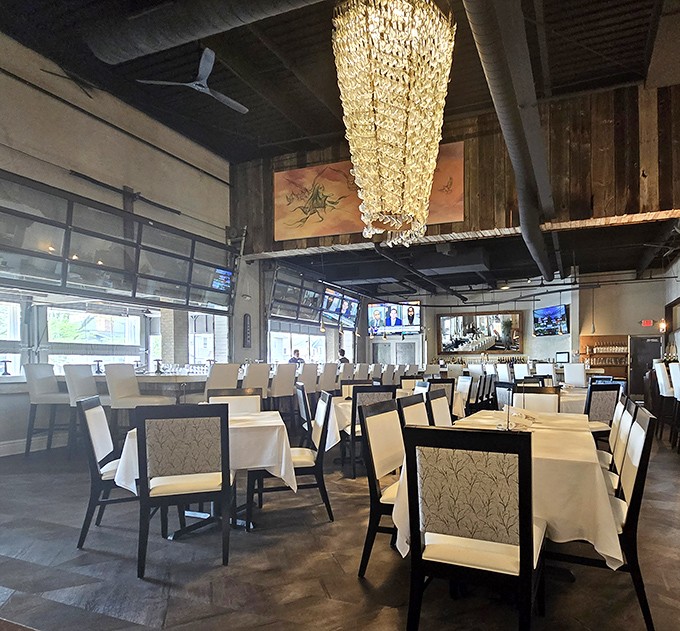 Inside, rustic meets refined with that showstopping crystal chandelier casting a warm glow over crisp white tablecloths &ndash; the perfect stage for the culinary performance about to unfold.