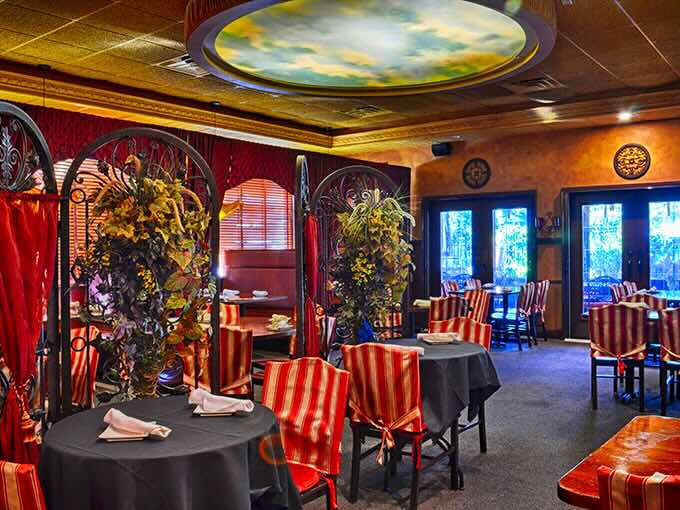 Step inside and suddenly you're not in Toledo anymore. That painted sky ceiling and those rich red draperies transport you straight to the Mediterranean.