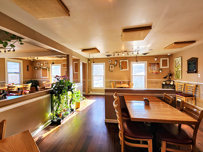A historic building transformed into a cozy dining haven where sunlight dances across wooden floors and plants bring the "garden" indoors.