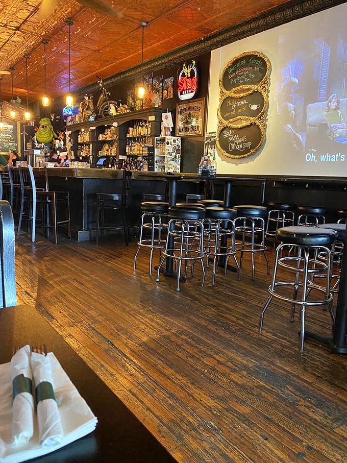 Copper ceiling tiles reflect warm light across a bar that's part punk rock museum, part breakfast sanctuary, and entirely worth the trip.