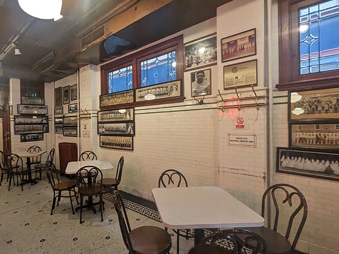 White-tiled walls adorned with decades of Pittsburgh memorabilia create a museum-like atmosphere where every table tells a story.