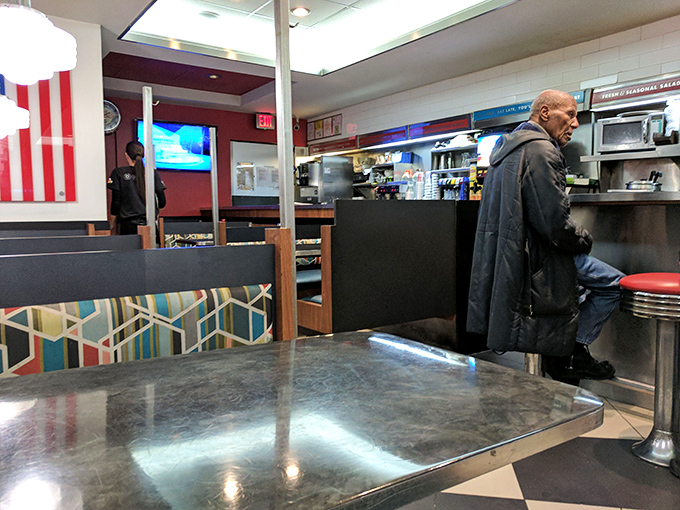 Inside, the quintessential diner experience awaits &ndash; counter seating, cozy booths, and the promise of conversations with strangers who might become friends.