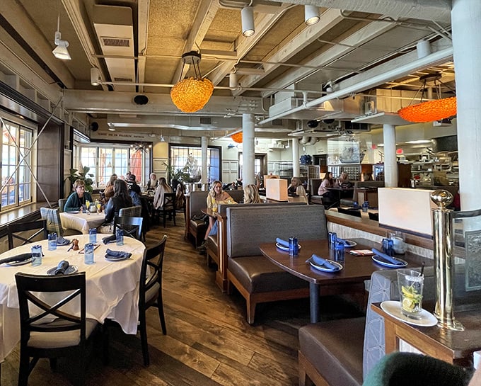 Inside, orange jellyfish-inspired lights hover above diners like friendly sea creatures, casting a warm glow over conversations and seafood revelations.