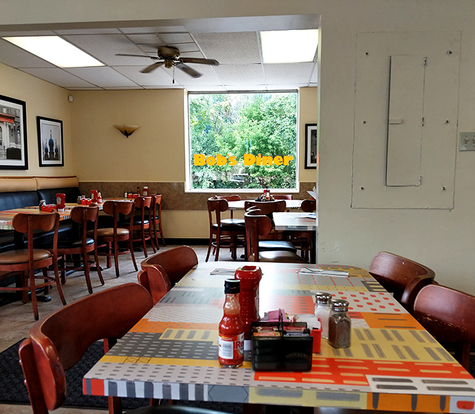 Classic diner ambiance with wooden chairs and colorful tabletops &ndash; where conversations flow as freely as the coffee.