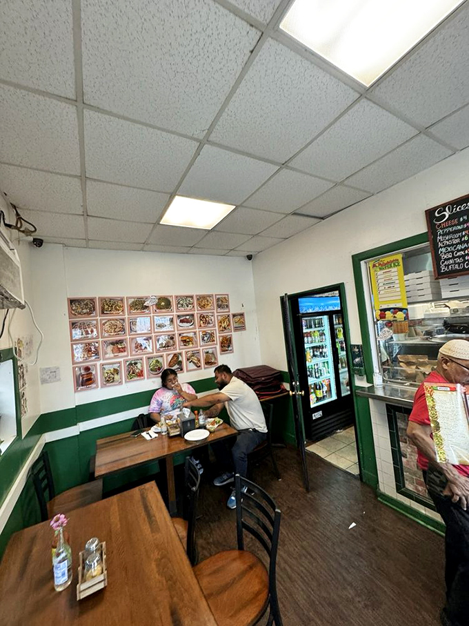 Inside San Lucas, where pizza dreams come true. The cozy interior with green wainscoting creates that perfect neighborhood vibe where regulars become family.