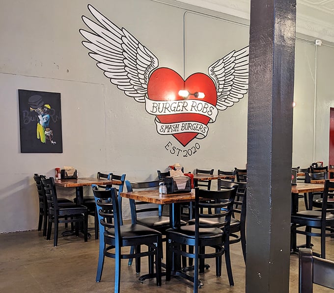 That winged heart logo isn't just decoration&mdash;it's a warning that these burgers might actually make your heart take flight. The simple interior lets the food do the talking.