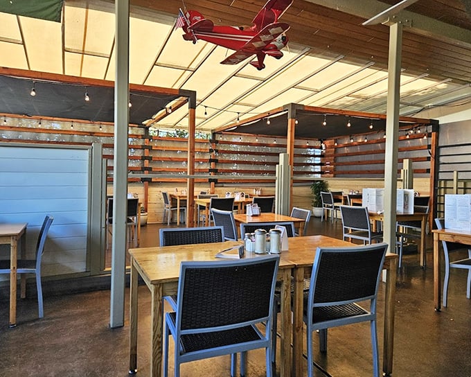 Wooden tables, black chairs, and a model airplane hanging from the ceiling—this isn't interior design, it's breakfast authenticity.