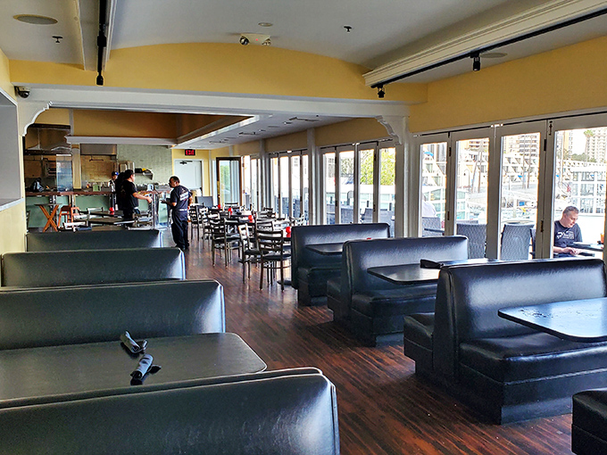 The dining room's navy blue booths and floor-to-ceiling windows create the perfect backdrop for seafood indulgence with a side of marina views.