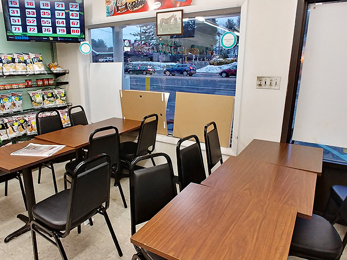 Simple tables, basic chairs, and a lottery board &ndash; because the real jackpot here is what comes from the kitchen.