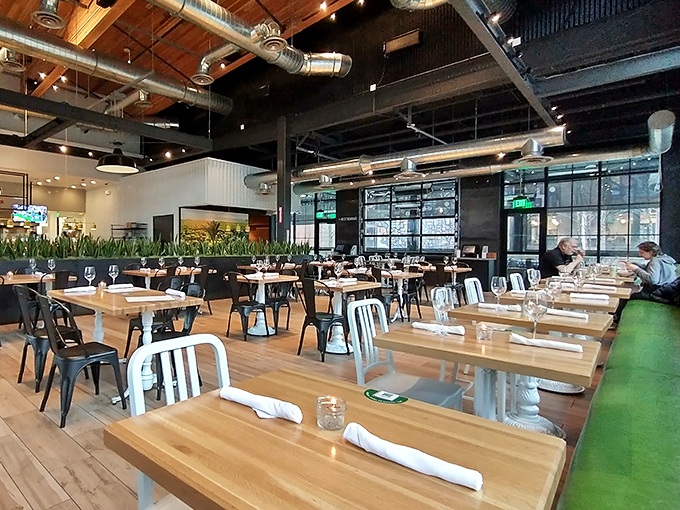 The interior strikes that perfect balance between industrial chic and cozy comfort. High ceilings and natural light make healthy eating feel like a stylish affair.