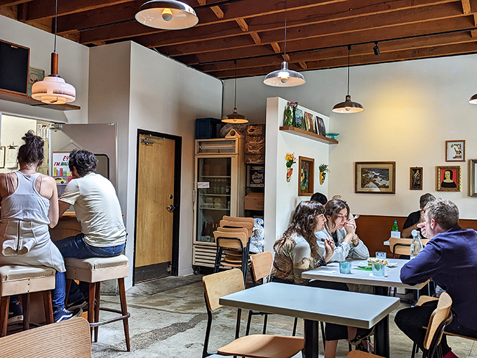 Inside, wooden ceiling beams and simple furnishings create that rare "instantly comfortable" vibe where strangers become friends over shared pizza revelations.