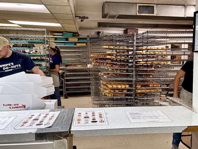 Behind the counter, where donut dreams come true. Racks of golden perfection await their destiny in those iconic white boxes.