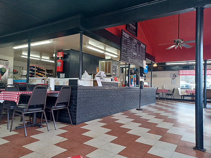Inside, the classic checkerboard floor and red ceiling create that perfect "I've found somewhere special" atmosphere. No designer needed&mdash;just decades of burger wisdom.