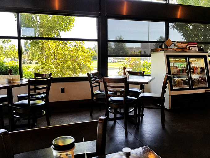 Sunlight streams through floor-to-ceiling windows, transforming an ordinary breakfast into a sun-dappled event. Like dining in a treehouse, but with better coffee.