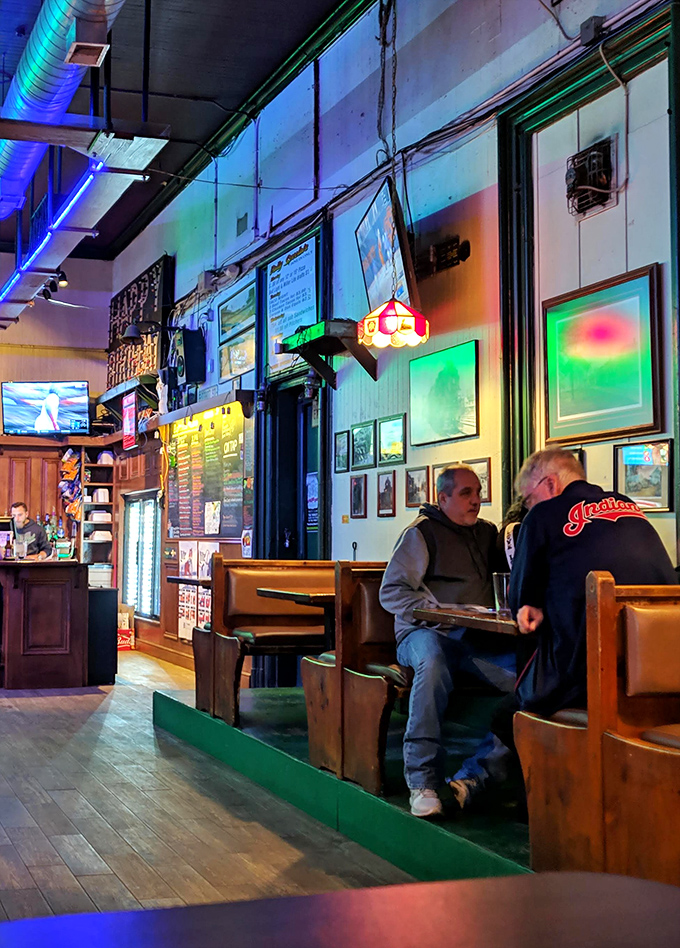 Inside, the colorful neon lights and wooden booths create that perfect "third place" atmosphere where conversations flow as freely as the beer. 