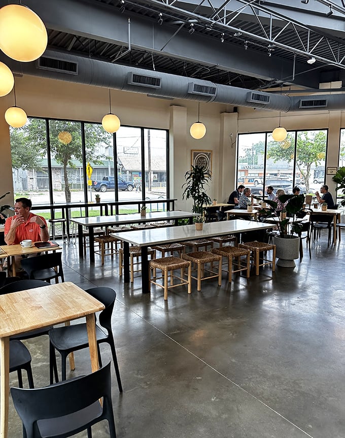 Industrial-chic meets cozy comfort in this airy space. The pendant lights cast a glow that makes everyone look like they're in a Nancy Meyers film.