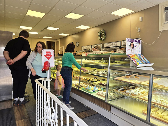 The moment of decision arrives at the display case. Like choosing between favorite children, only these children are made of sugar, flour, and century-old recipes.