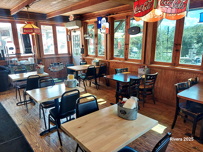 Rustic wooden charm meets Coca-Cola nostalgia inside this burger sanctuary, where sunlight streams through windows onto tables that have hosted thousands of happy food moments.