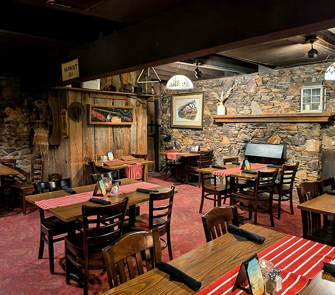 Stone walls and wooden beams create a dining room that feels like a secret hideaway. Those red-checkered tablecloths aren't just decoration&mdash;they're a promise.