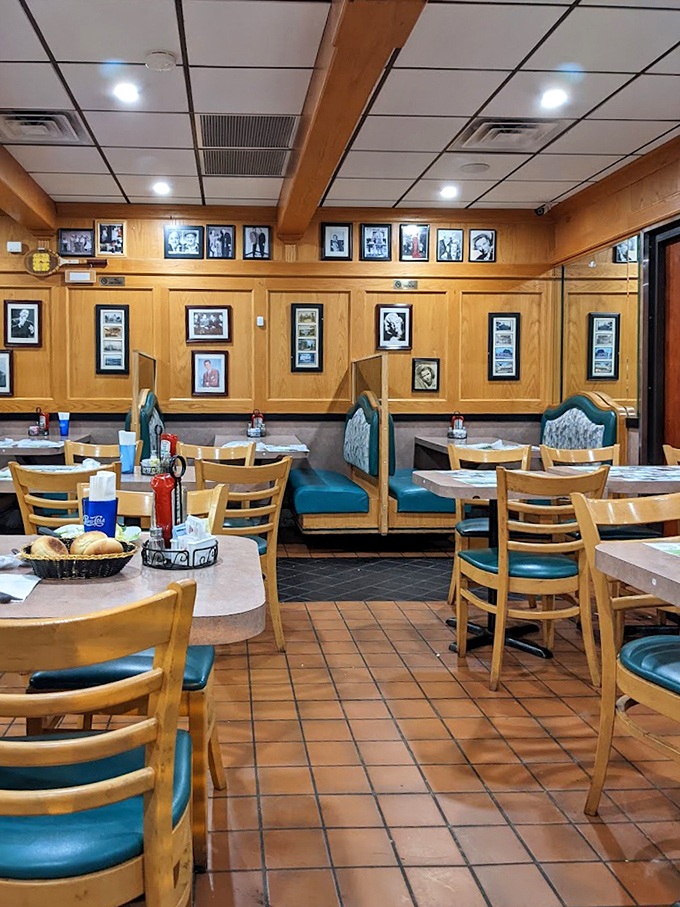 Wood paneling, teal booths, and black-and-white photographs create that perfect time-capsule feeling where comfort food memories are made daily.