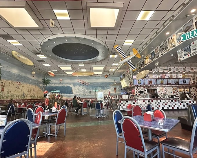 Step inside and you're transported to a bygone era where model airplanes soar overhead and beach murals transform ordinary meals into coastal getaways.