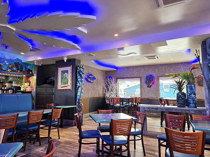 Step inside and you're swimming in ambiance. The blue-lit interior with surfboard ceiling accents creates an underwater dreamscape perfect for seafood indulgence.