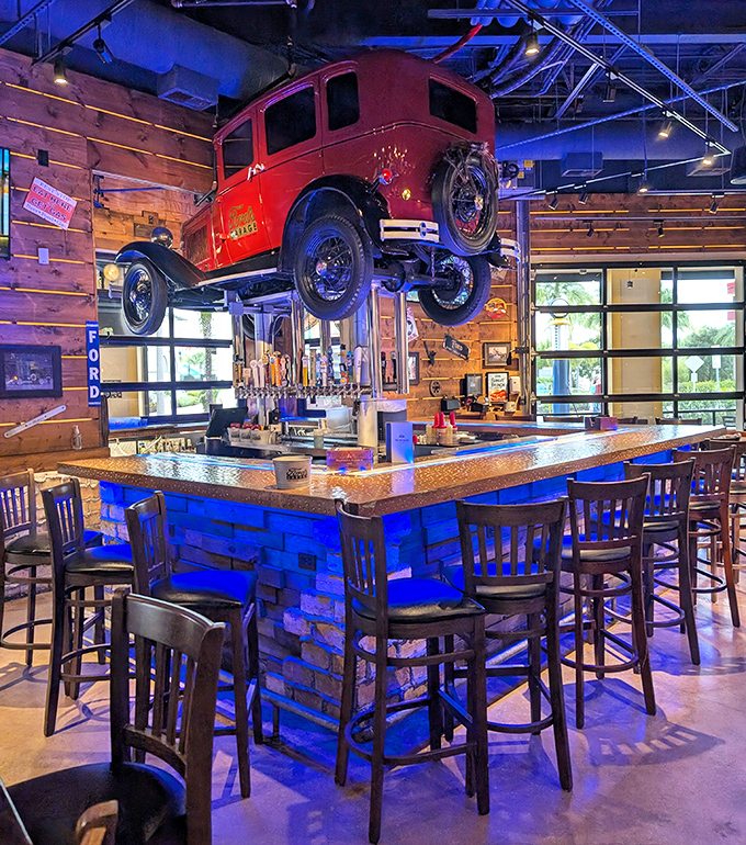 Gravity-defying automotive magic! A classic red Ford hangs above the bar, creating the perfect conversation starter while you sip your craft beer.