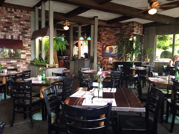 Exposed brick and wooden beams create the kind of atmosphere where stories flow as freely as the wine.