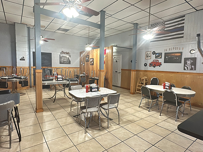 Classic Americana lives in this dining room where wooden wainscoting meets ceiling fans, creating the perfect backdrop for serious burger contemplation.