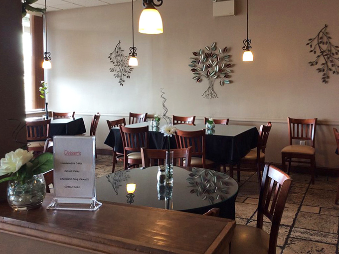 Simple elegance defines the dining room, where metal tree art and pendant lighting create an atmosphere that says "casual" but whispers "quality."